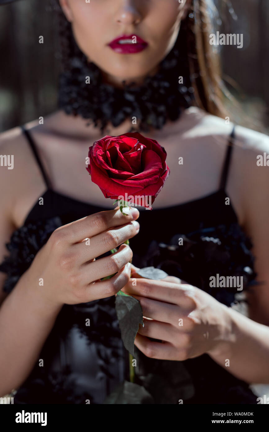 Gothic girl holding black rose hi-res stock photography and images - Alamy