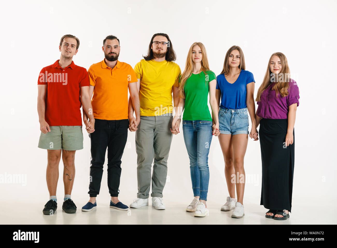 Young man and woman weared in LGBT flag colors on white background ...