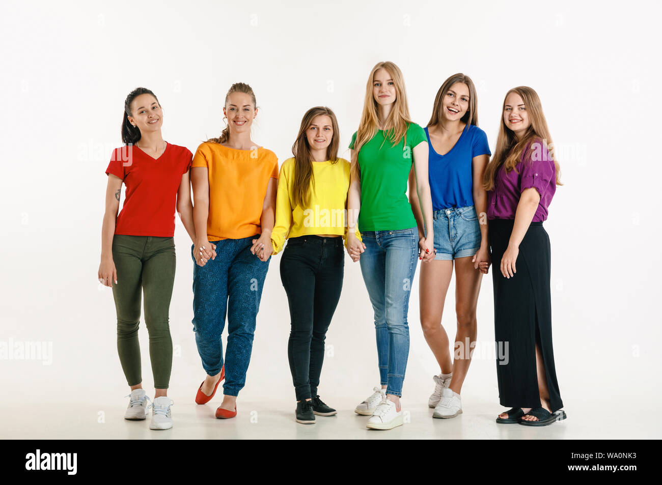Young man and woman weared in LGBT flag colors on white background ...