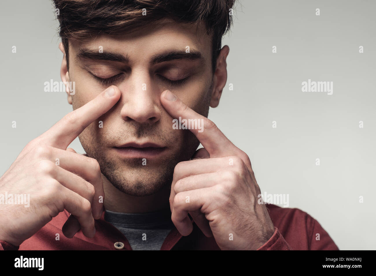 blind man pointing at closed eyes isolated on grey, human emotion and ...