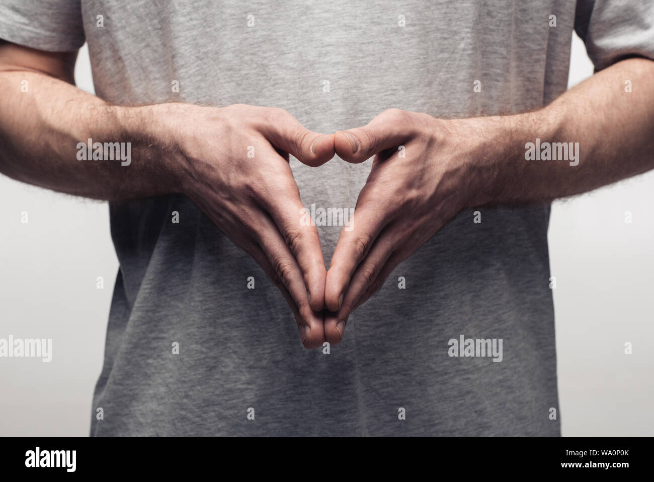 partial view of man showing steeple gesture while using body language ...