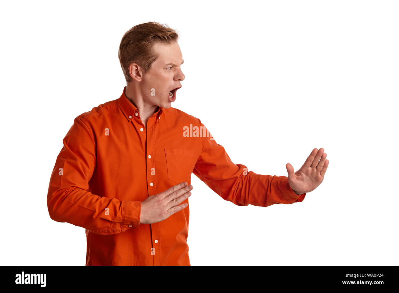 Close-up portrait of a young nice ginger fellow in a stylish orange ...