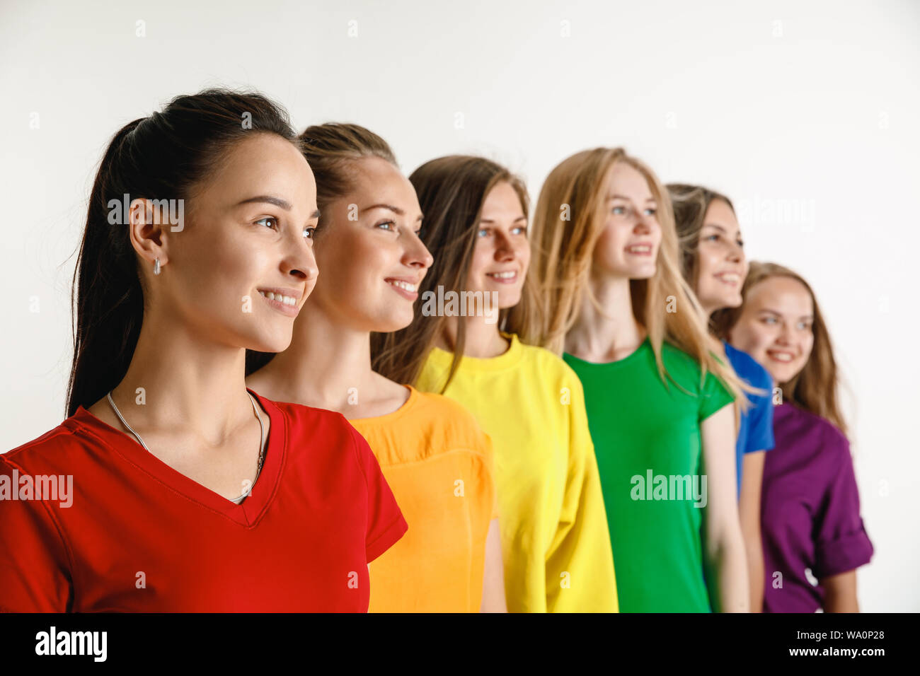 Young women weared in LGBT flag colors isolated on white background ...