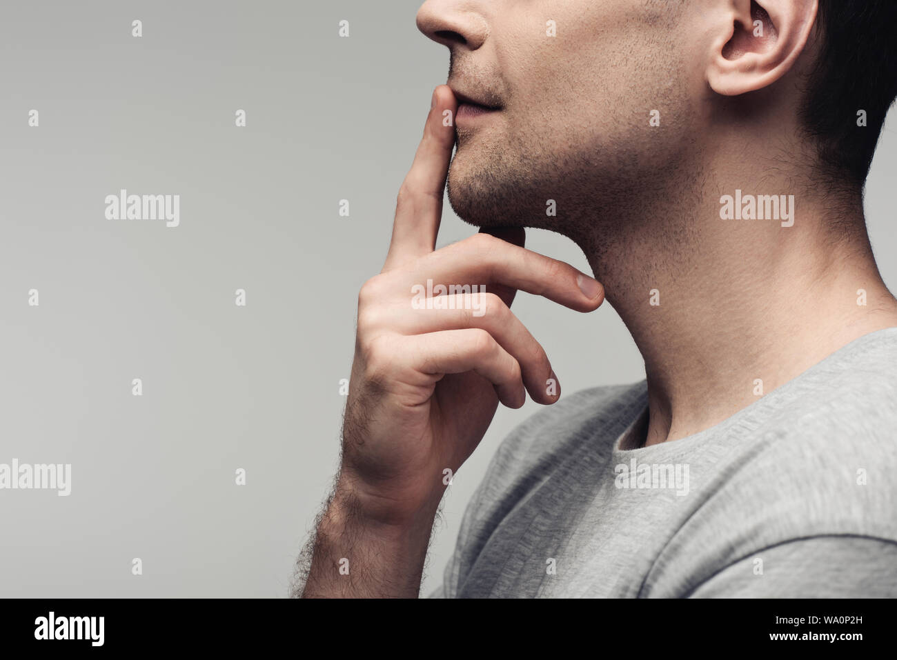 partial view of dumb man showing silence sign isolated on grey, human ...