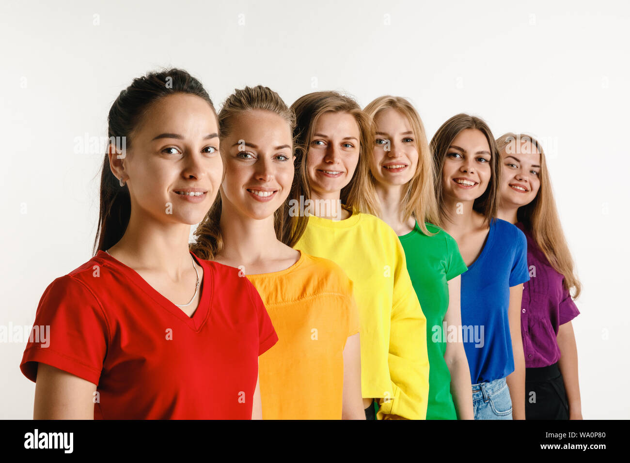 Young women weared in LGBT flag colors isolated on white background ...