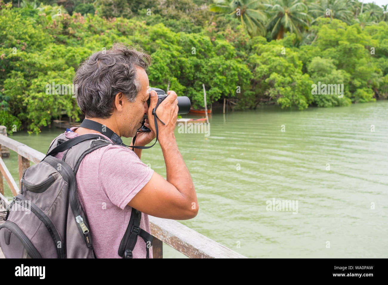 Ilha de Itamaraca, Brazil - Circa August 2019: Man on a bridge taking a ...