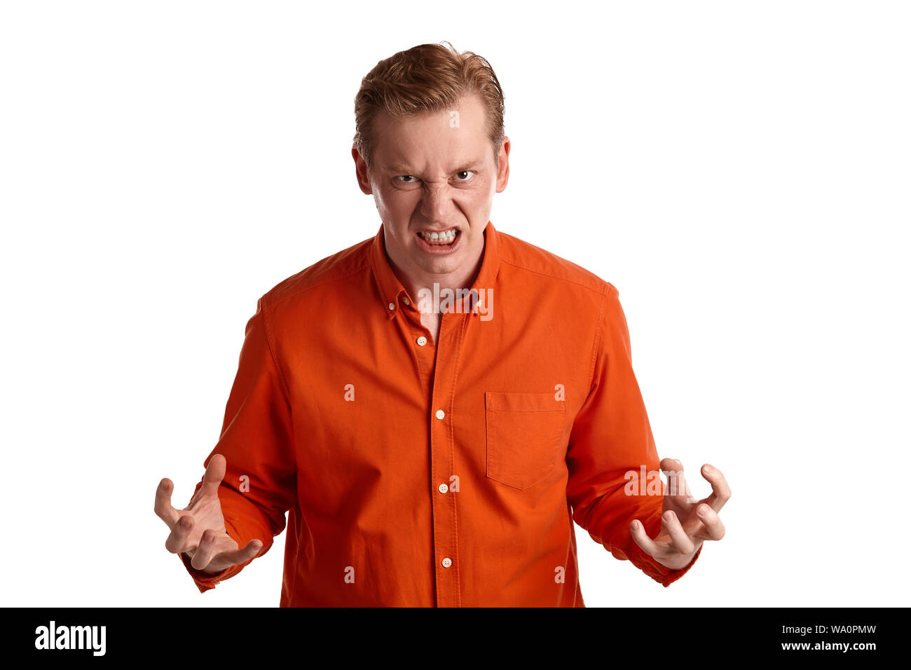 Close-up portrait of a young elegant ginger male in a stylish orange ...