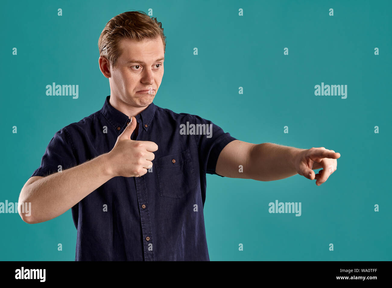 Close-up portrait of a young stylish ginger fellow in a navy t-shirt ...