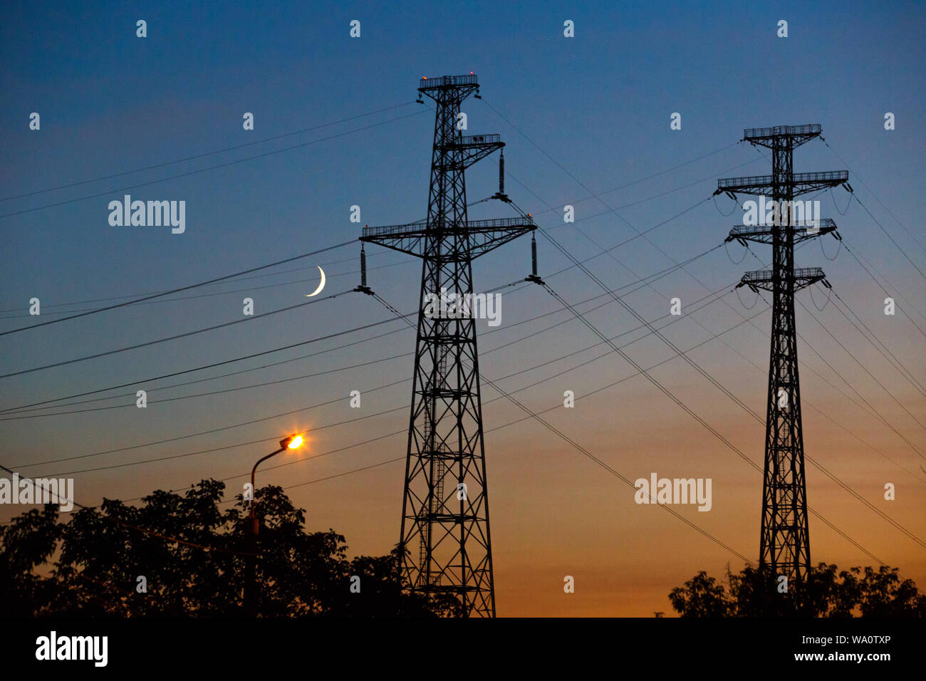 Electrical lines under a night sky with moon. power electric line and ...