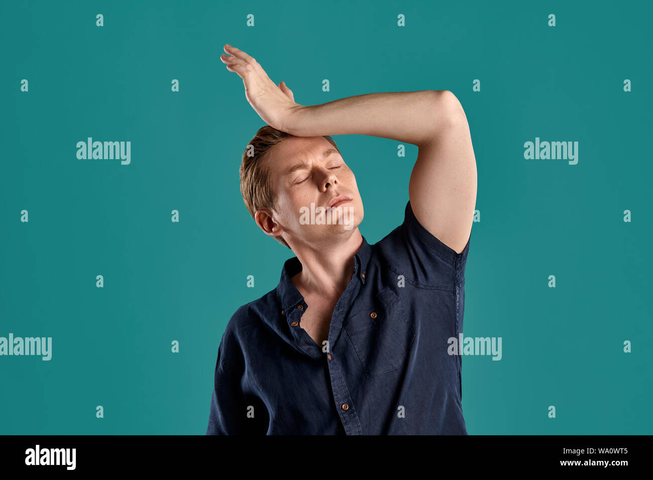 Close-up portrait of a young smart ginger man in a stylish navy t-shirt ...