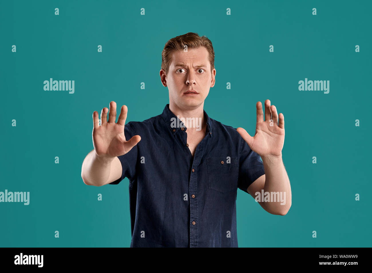 Close-up portrait of a young smart ginger male in a stylish navy t ...