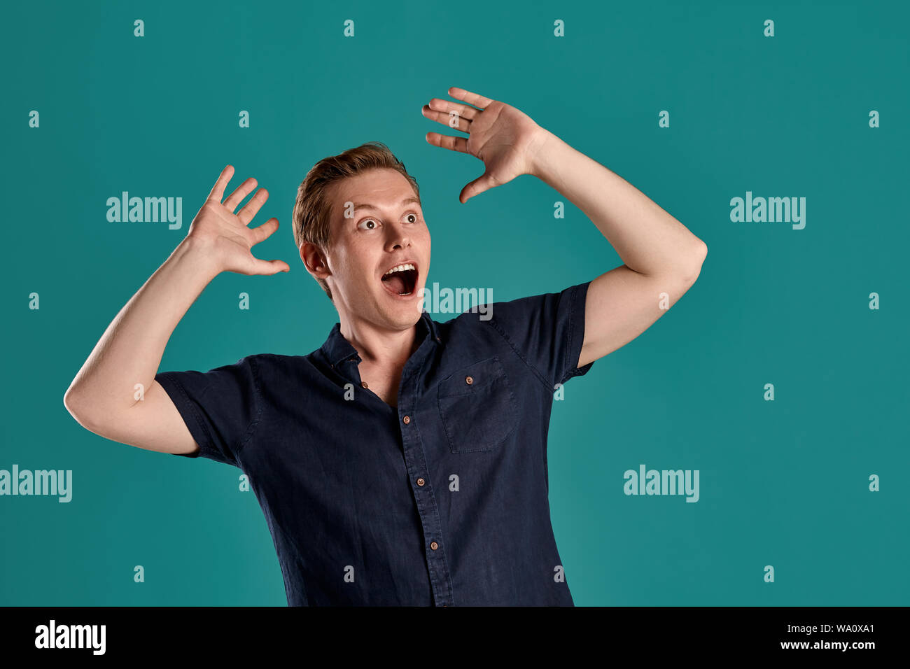 Close-up portrait of a young goodly ginger man in a stylish navy t ...