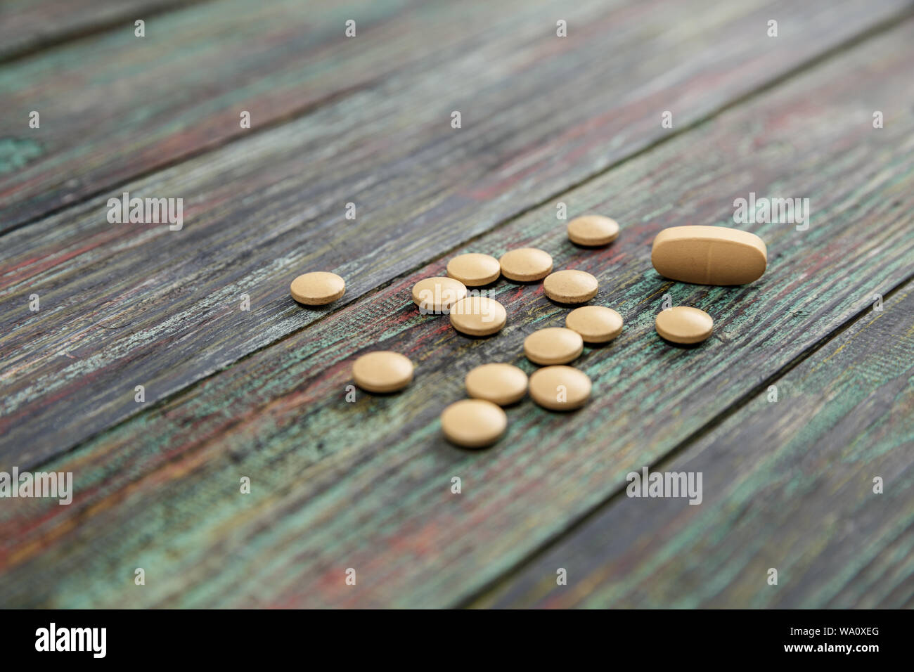 Beige pill on a wooden background with copy space. Global healthcare ...