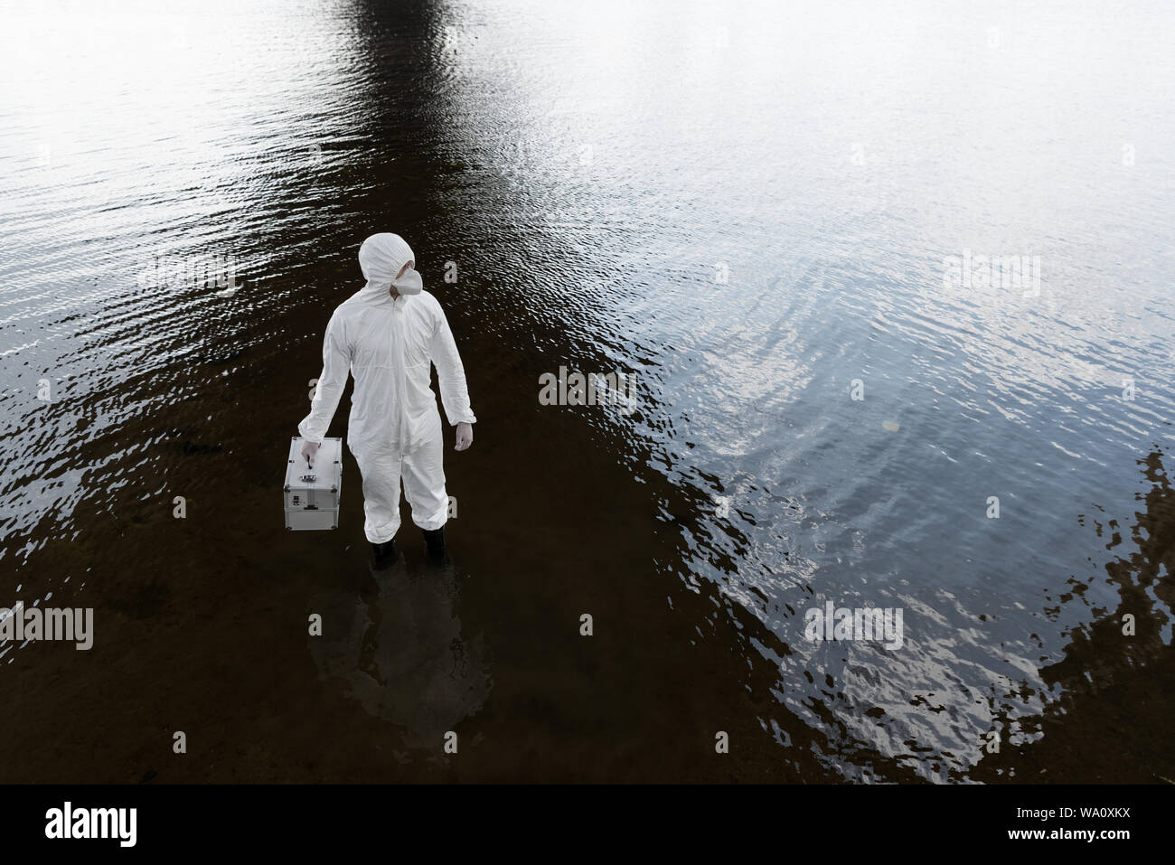 overhead view of water inspector in protective costume holding ...