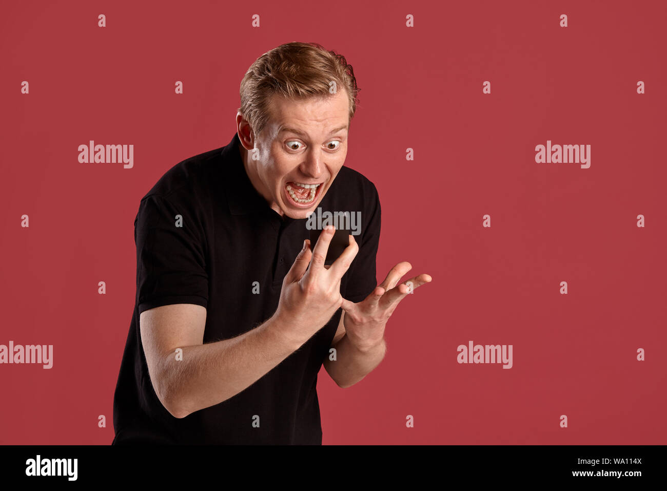 Close-up portrait of a young attractive ginger guy in a stylish black t ...