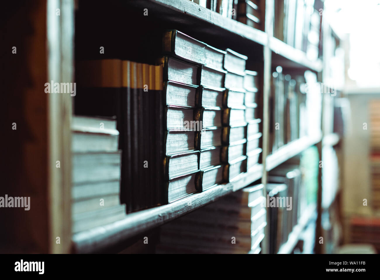selective focus of retro books on wooden shelves in library Stock Photo ...