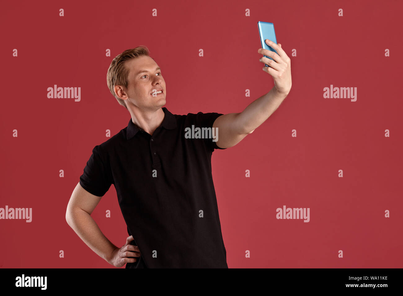 Close-up portrait of a young smart ginger fellow in a stylish black t ...