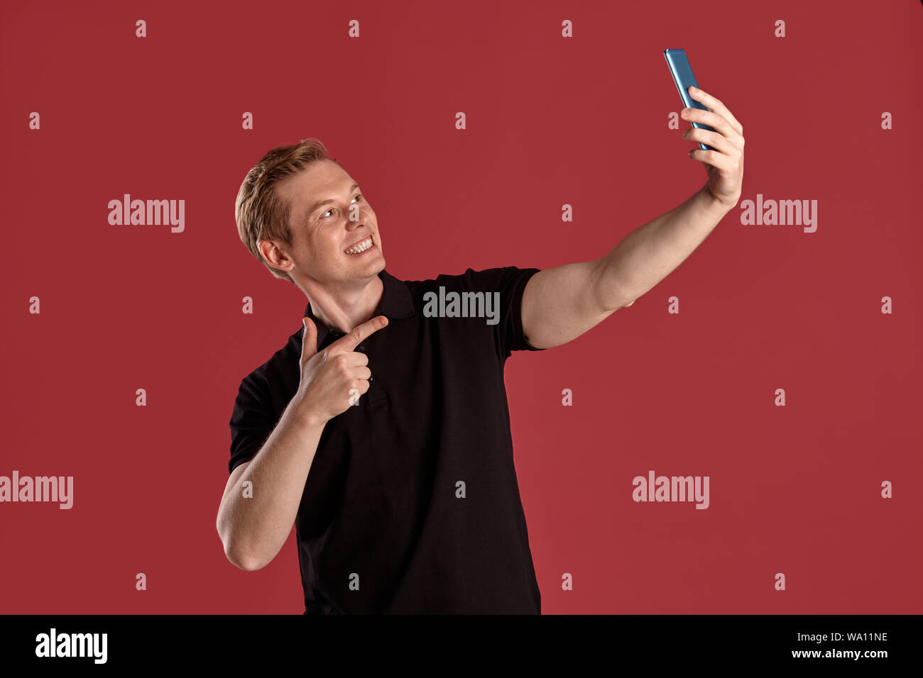 Close-up portrait of a young smart ginger person in a stylish black t ...