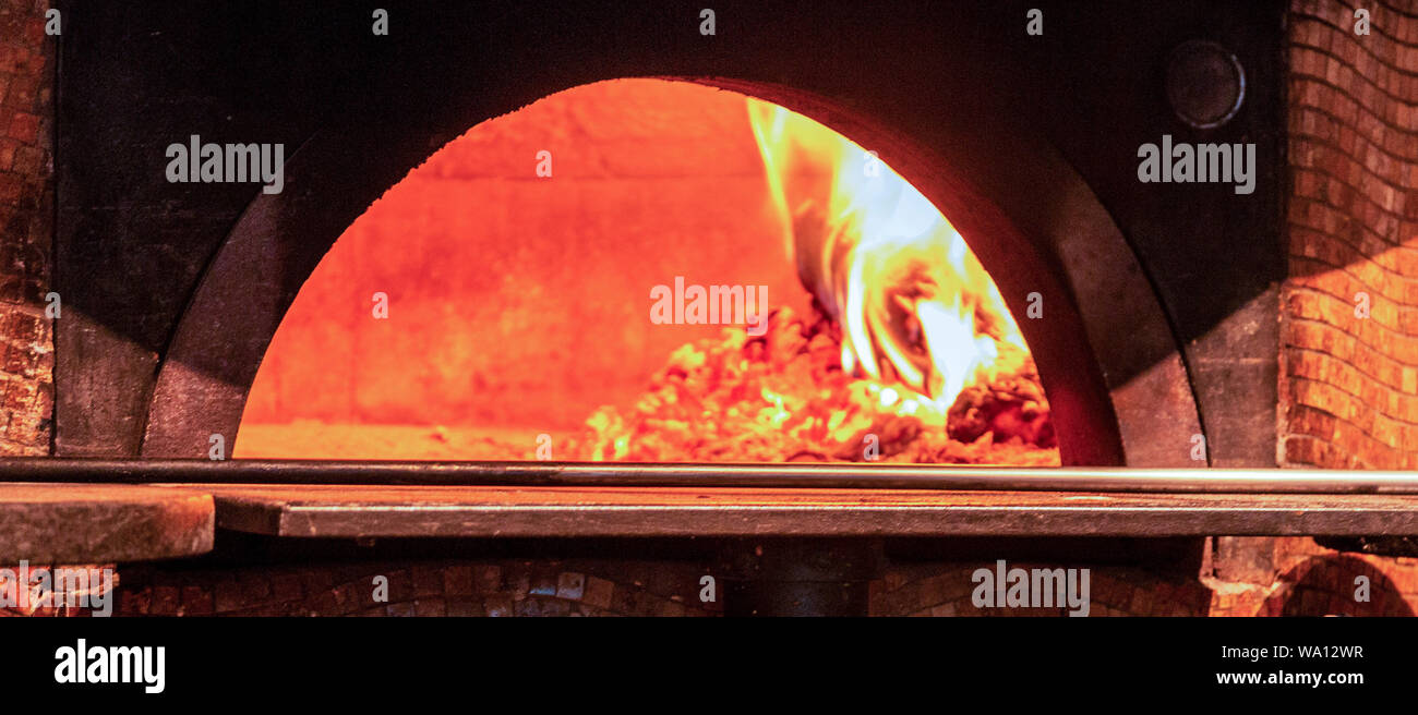 A wood fired brick oven is hot and ready to make pizza at an Italian ...