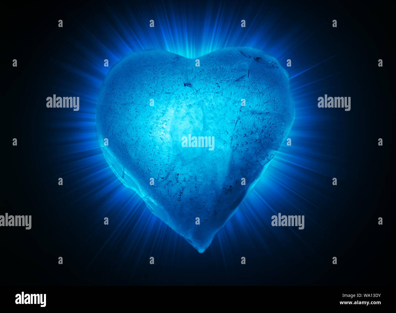 Ice frozen heart symbol of blue color close-up glowing in blue cold ...