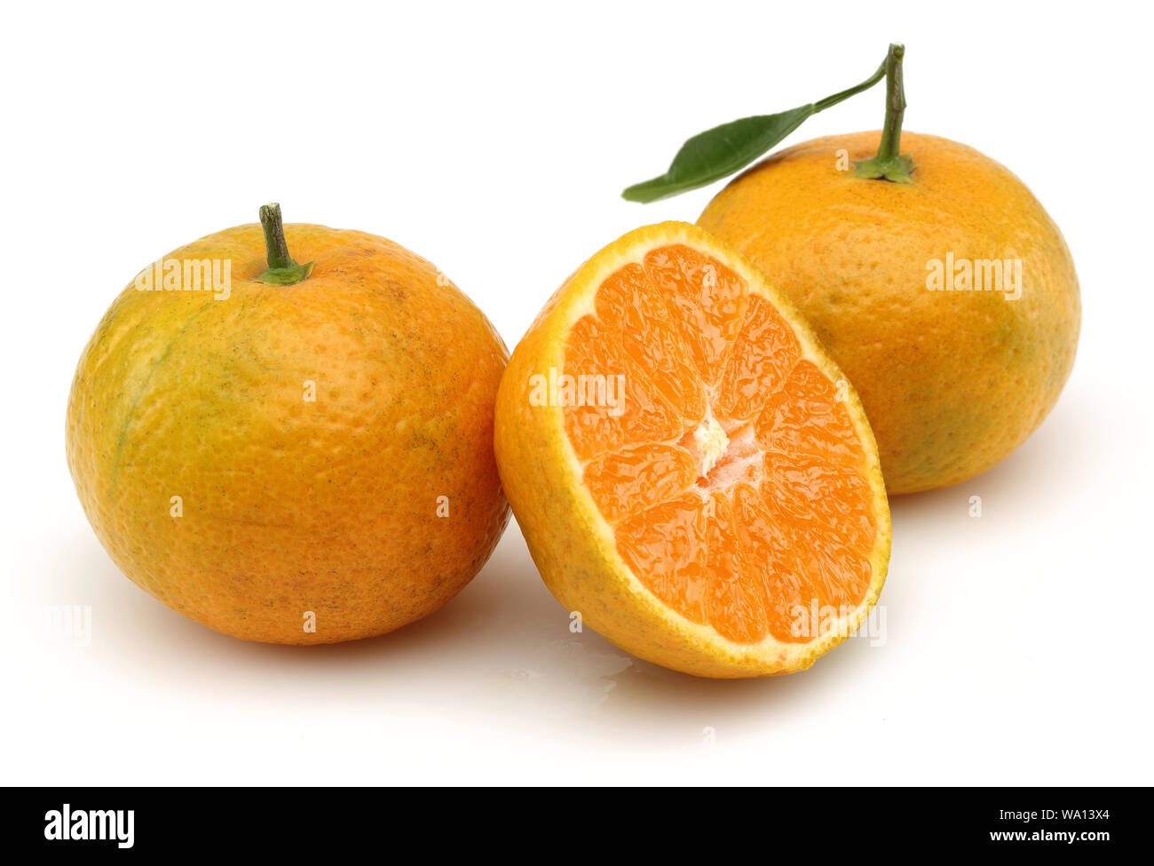 Whole and half tangerine with leaf isolated on white background Stock ...