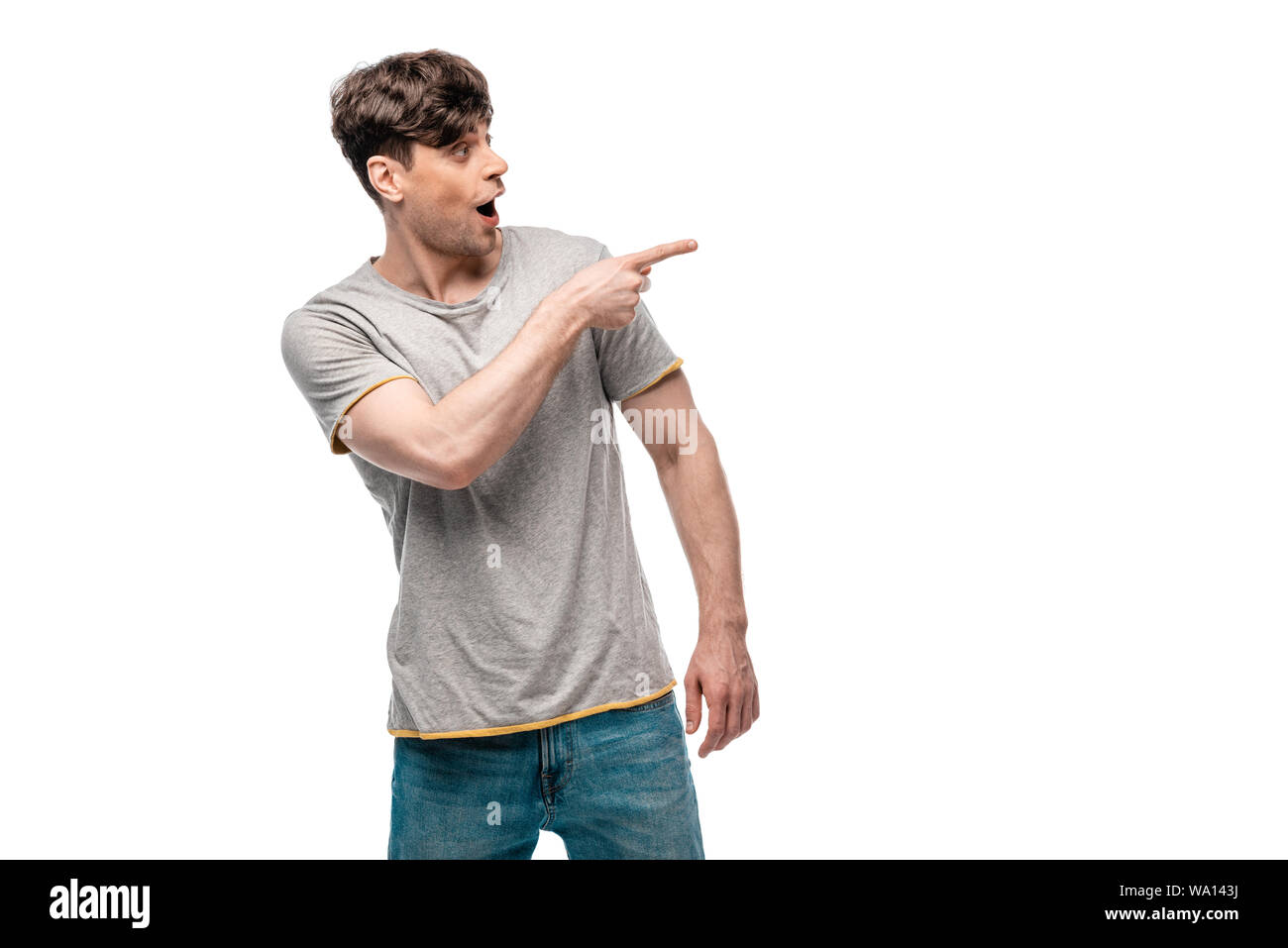 Surprised young man pointing hi-res stock photography and images - Alamy