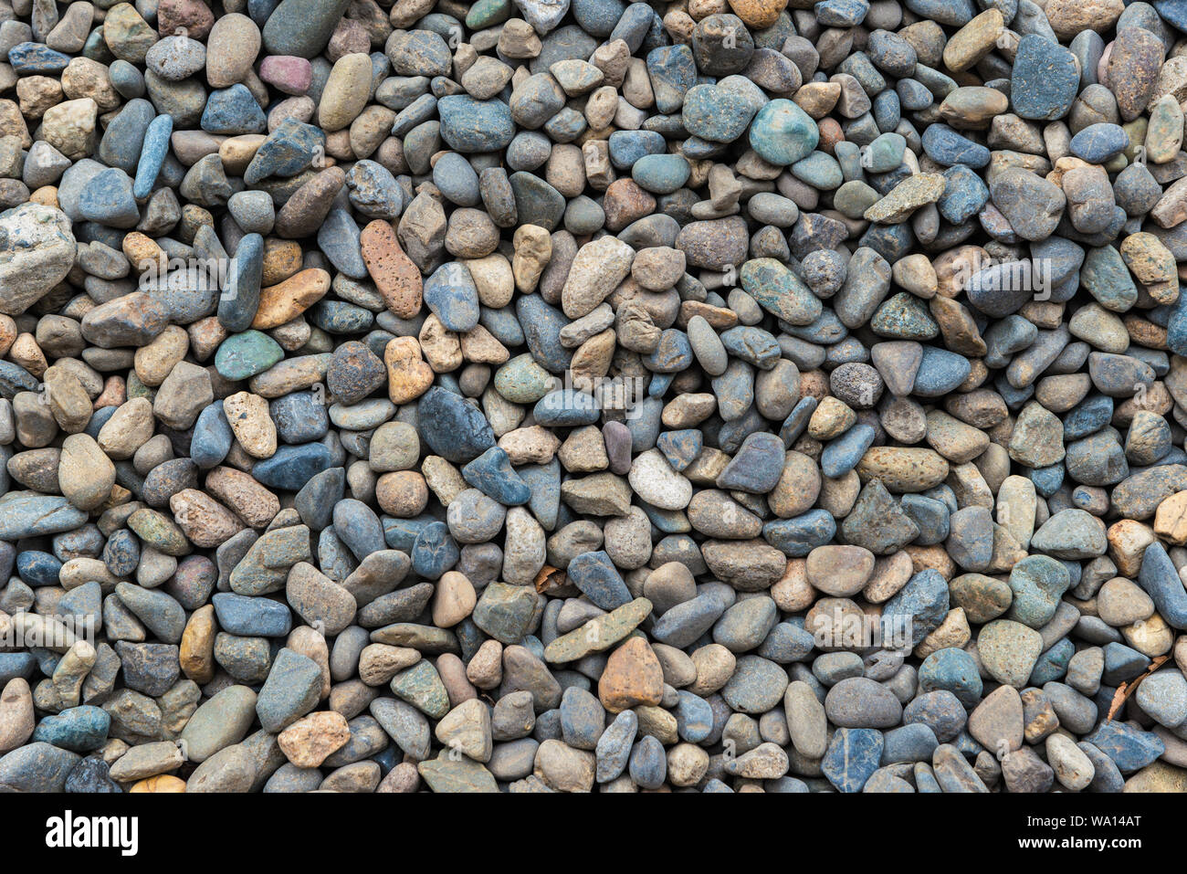 Multicolor stone pebbles ground as background Stock Photo - Alamy