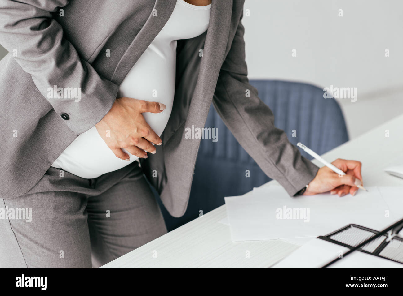 Woman in suit writing notes hi-res stock photography and images - Alamy