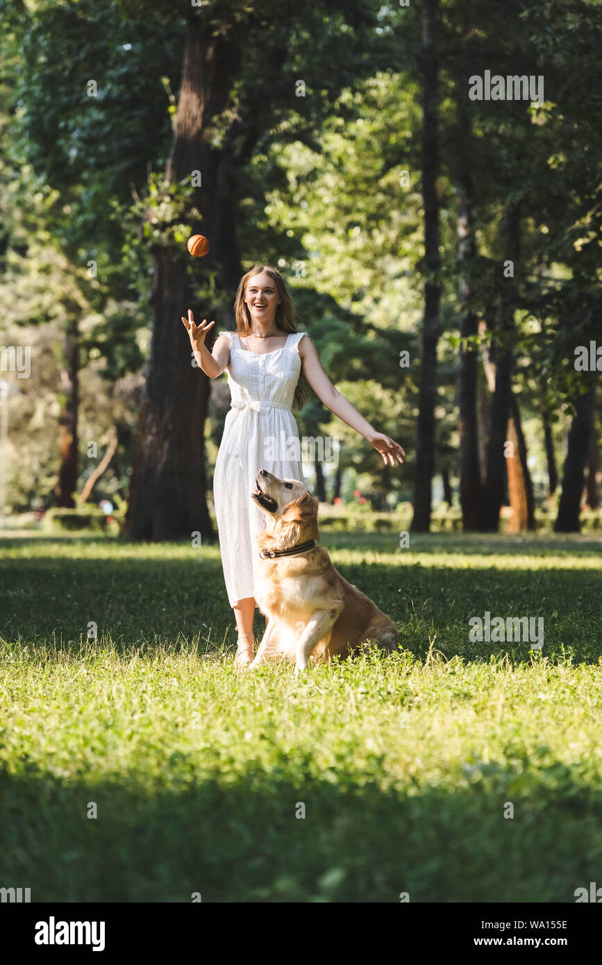 full length view of beautiful girl in white dress playing ball with ... full length view of beautiful girl in white dress playing ball with ...