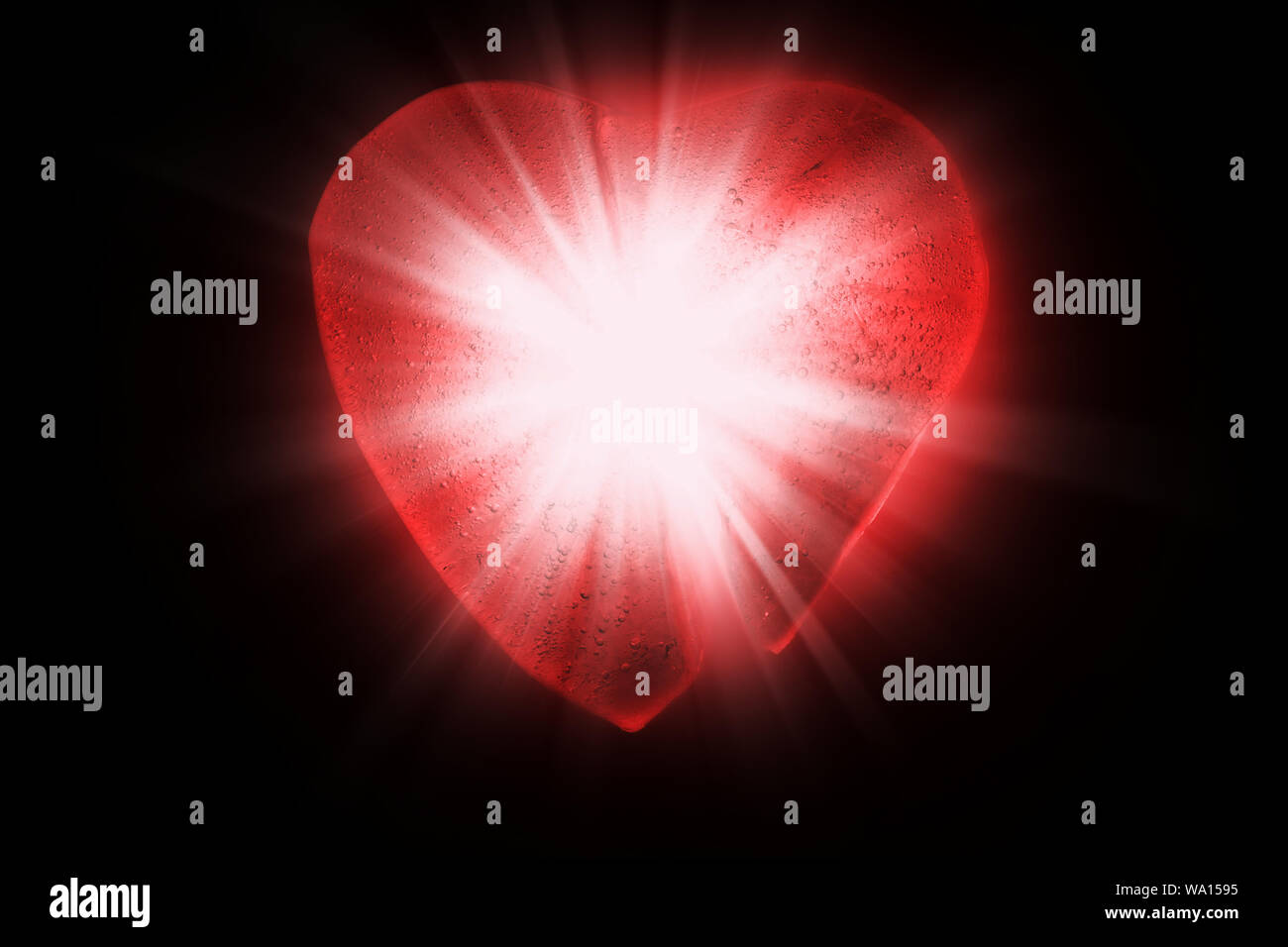 Ice frozen broken in half heart symbol of a soft pink color close-up ...