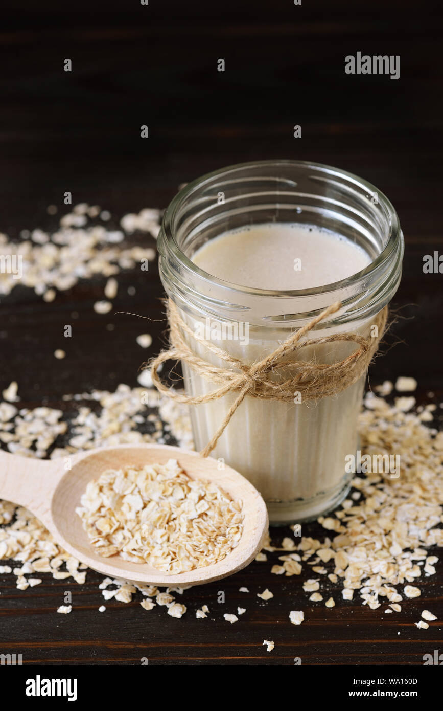 Glass of vegan oat milk and Oat on a table, space for text. Food ...