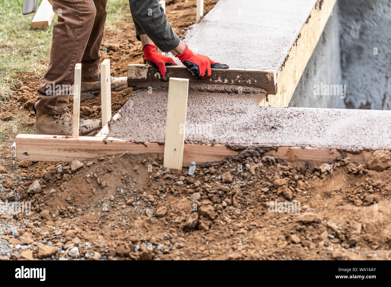 Construction Worker Leveling Wet Cement Into Wood Framing Stock Photo ...