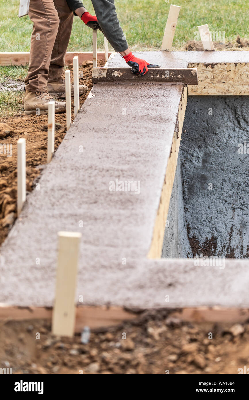 Construction Worker Leveling Wet Cement Into Wood Framing Stock Photo ...