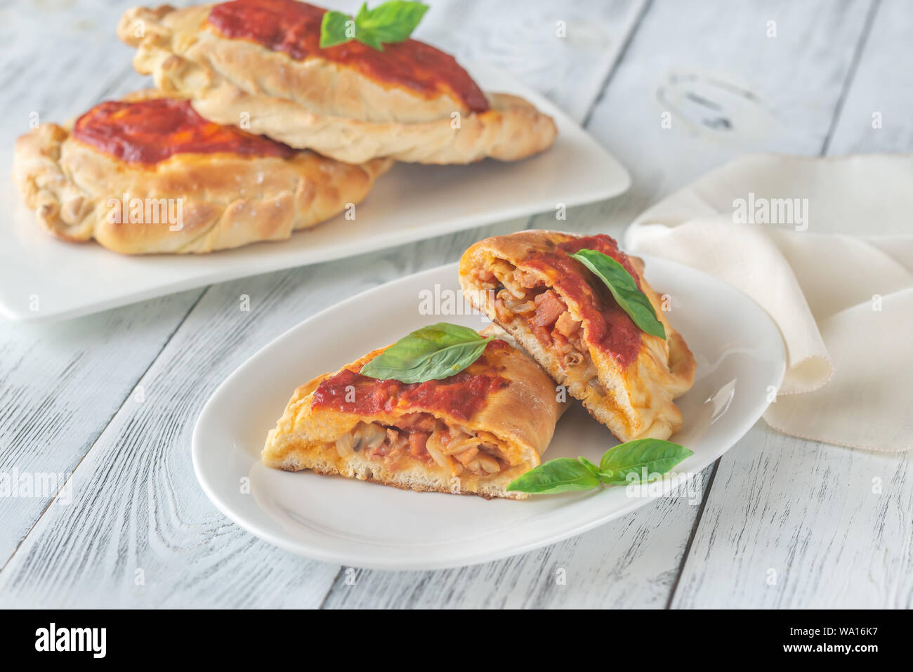 Homemade calzone stuffed with pancetta and mushrooms: cross section ...