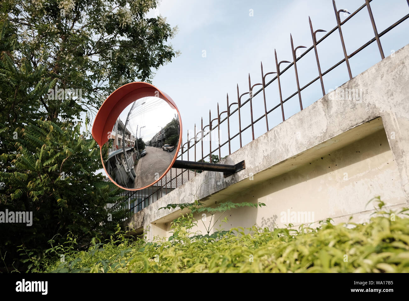 Traffic mirror on the wall at intersection or curve of road Stock Photo ...