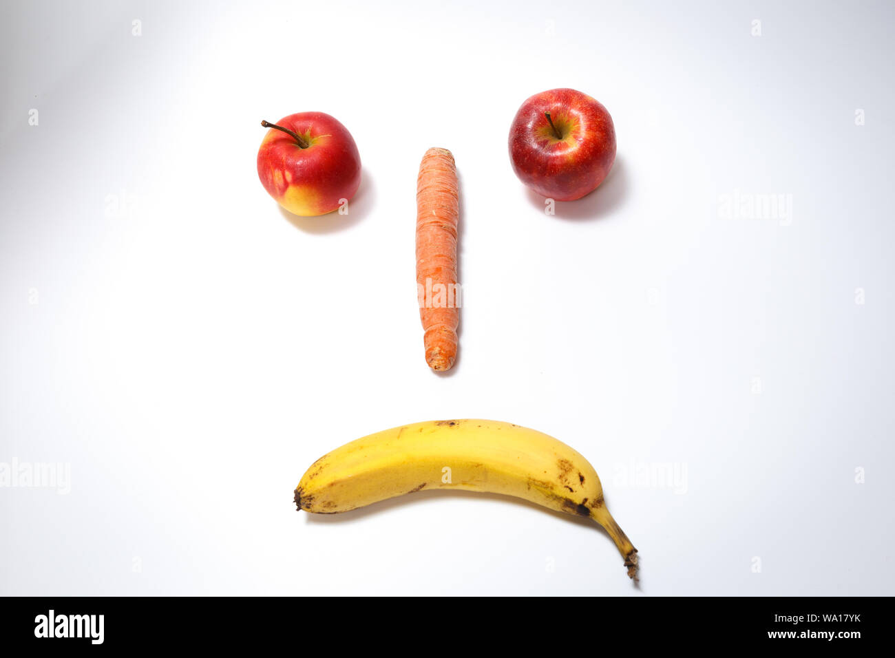 Sad smiling fruit face isolated on white background Stock Photo - Alamy