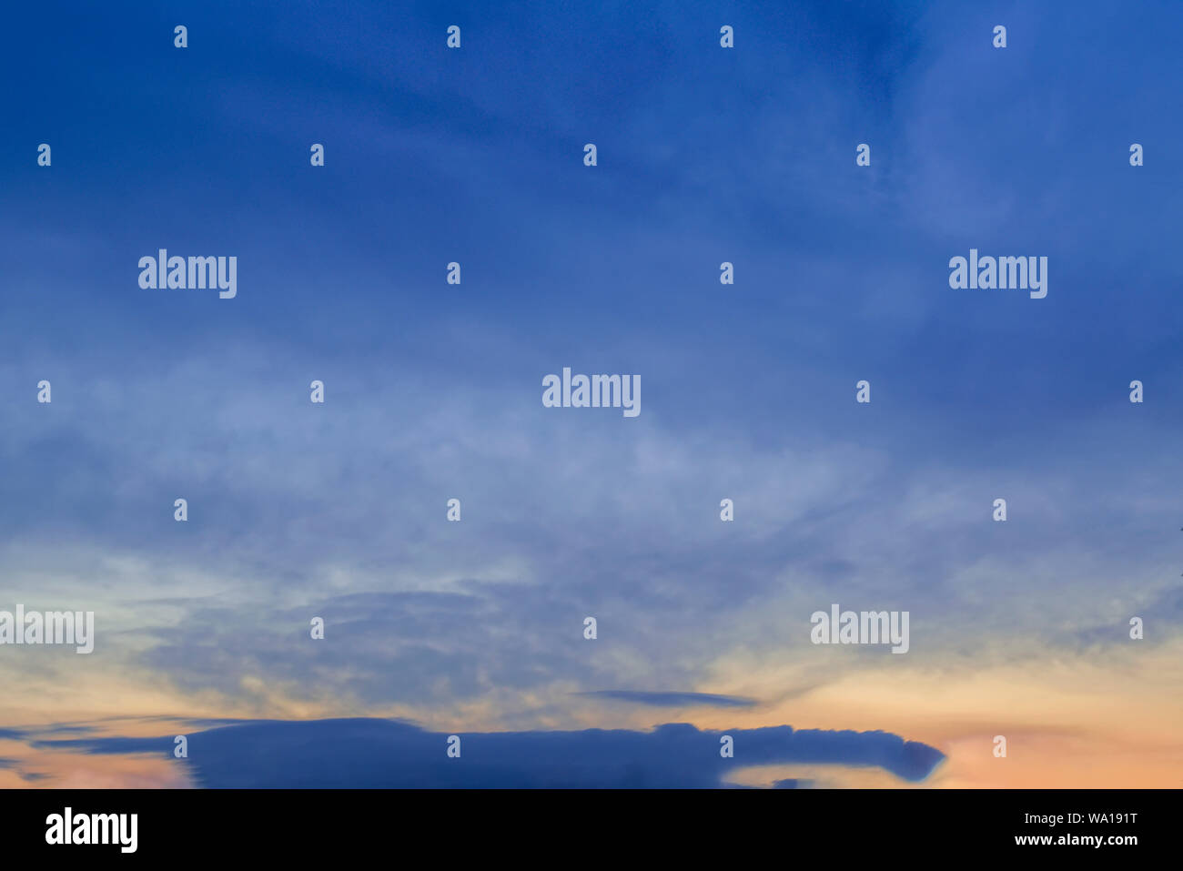 Cumulus sunset clouds with sun setting down. The sky with dark clouds ...