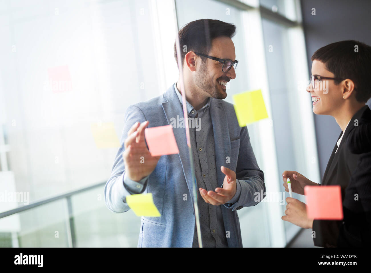 Business people meeting at office and use post it notes to share idea ...