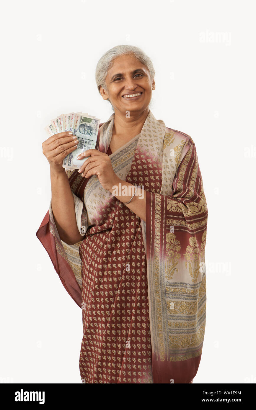 Old woman showing banknotes and smiling Stock Photo - Alamy
