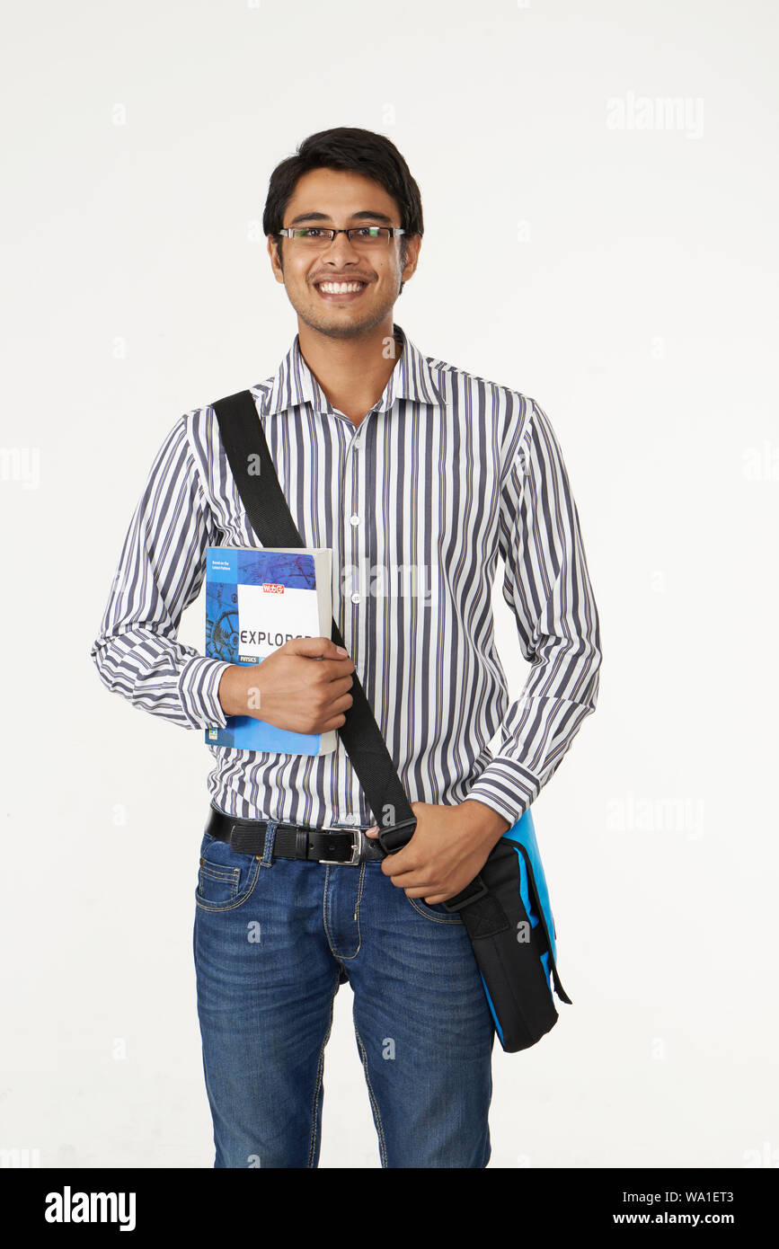 College student holding book Stock Photo - Alamy