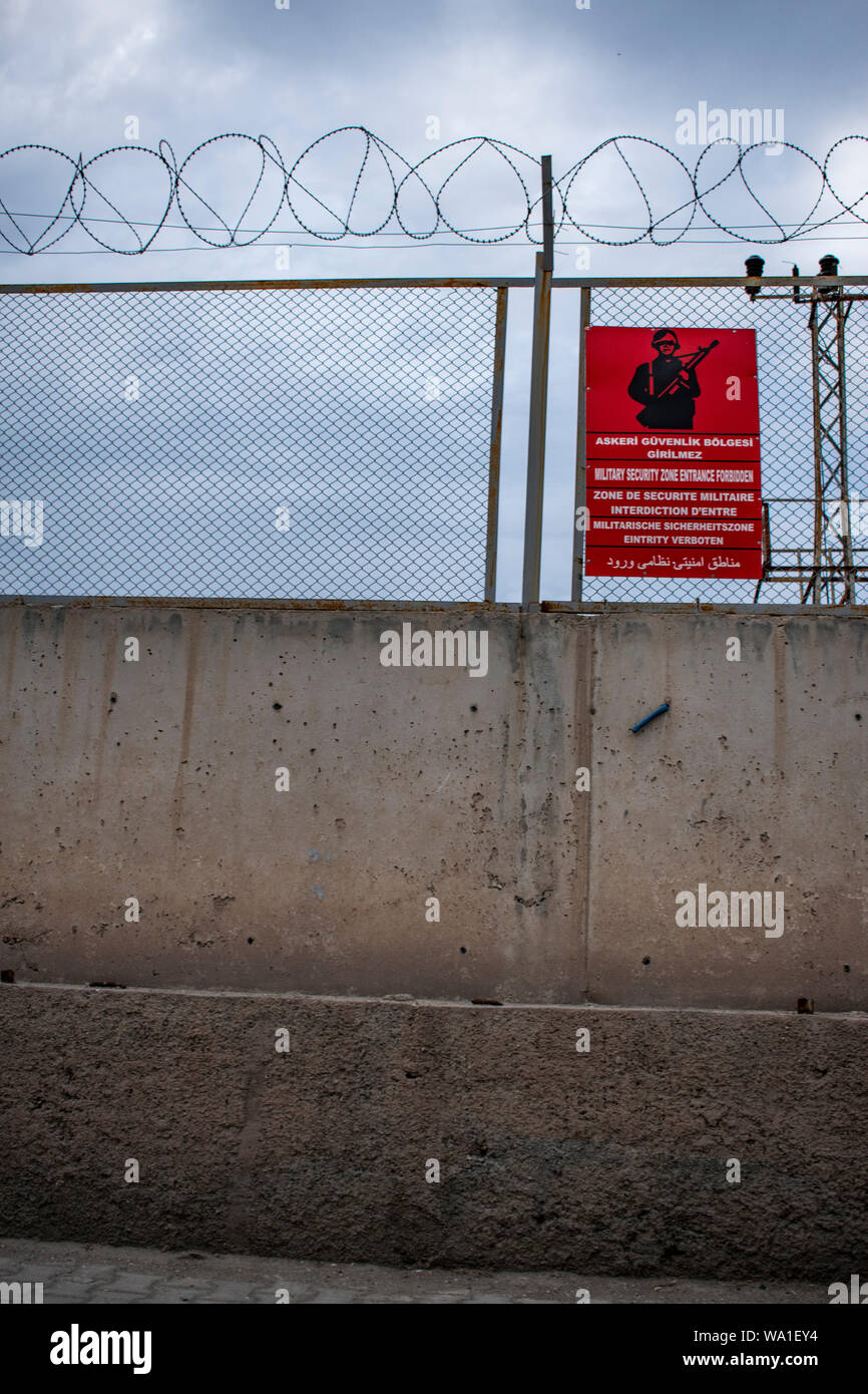 Dogubayazıt, Turkey: fence with barbed wire and red sign of military ...
