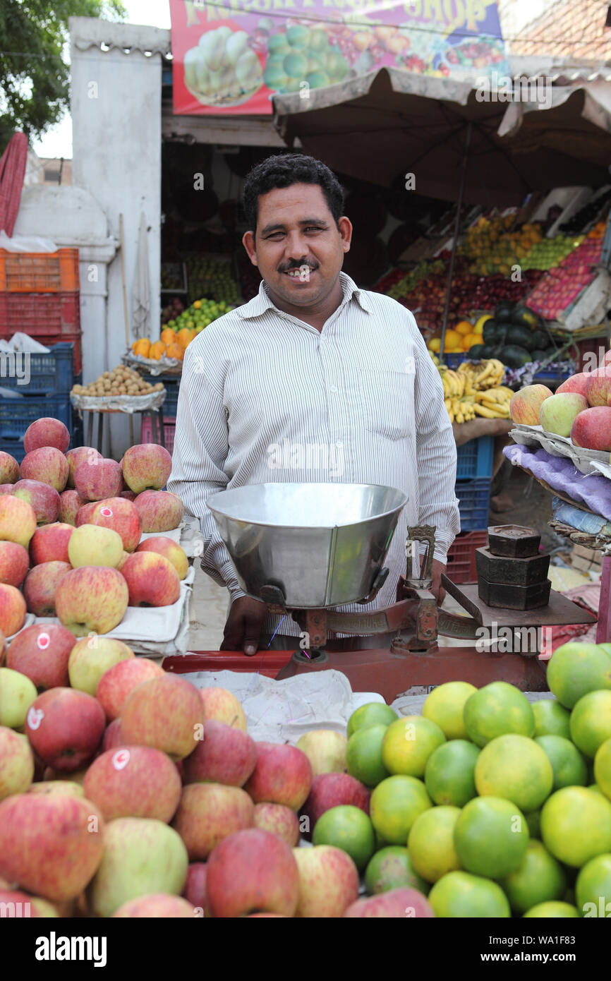 Vendor selling fruits at a market stall Stock Photo - Alamy