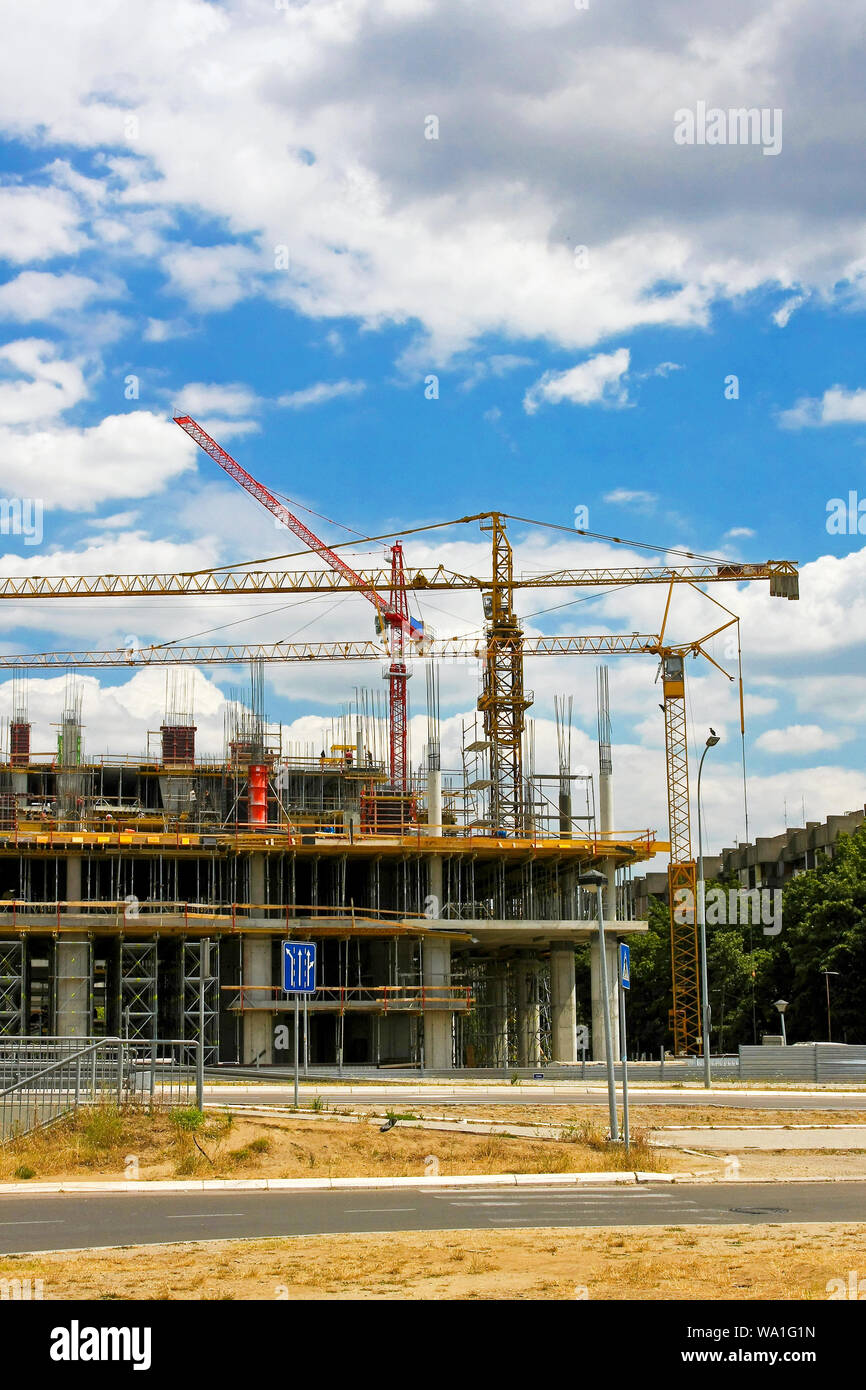Big building construction site with three cranes Stock Photo - Alamy
