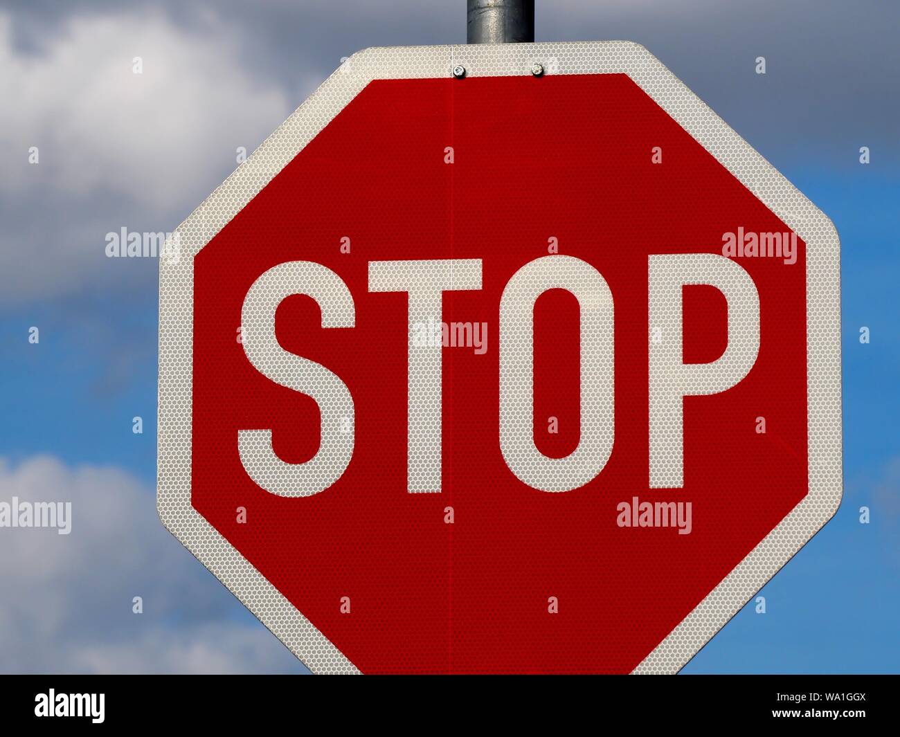 Stop sign in front of blue sky Stock Photo - Alamy