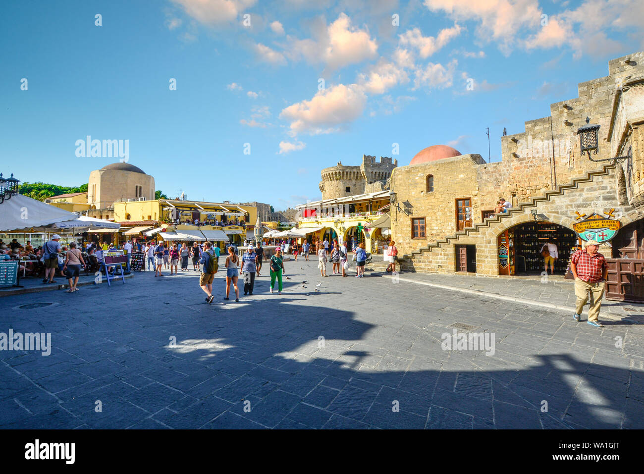 Tourists sight-see, shop and dine in the historic Hippocrates Square ...