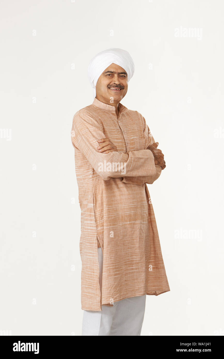 Rural man standing with his arms crossed and smiling Stock Photo - Alamy