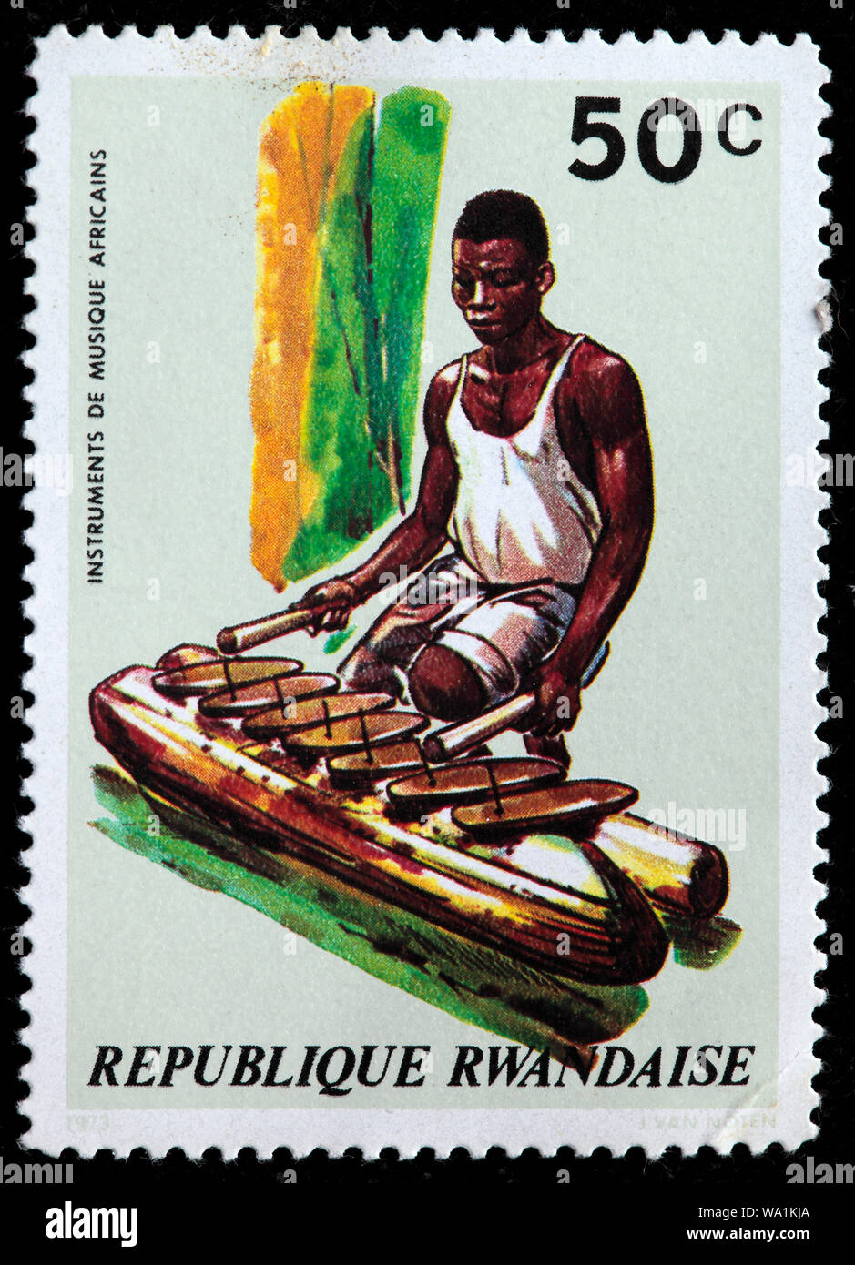 Man playing on traditional musical instrument, postage stamp, Rwanda ...