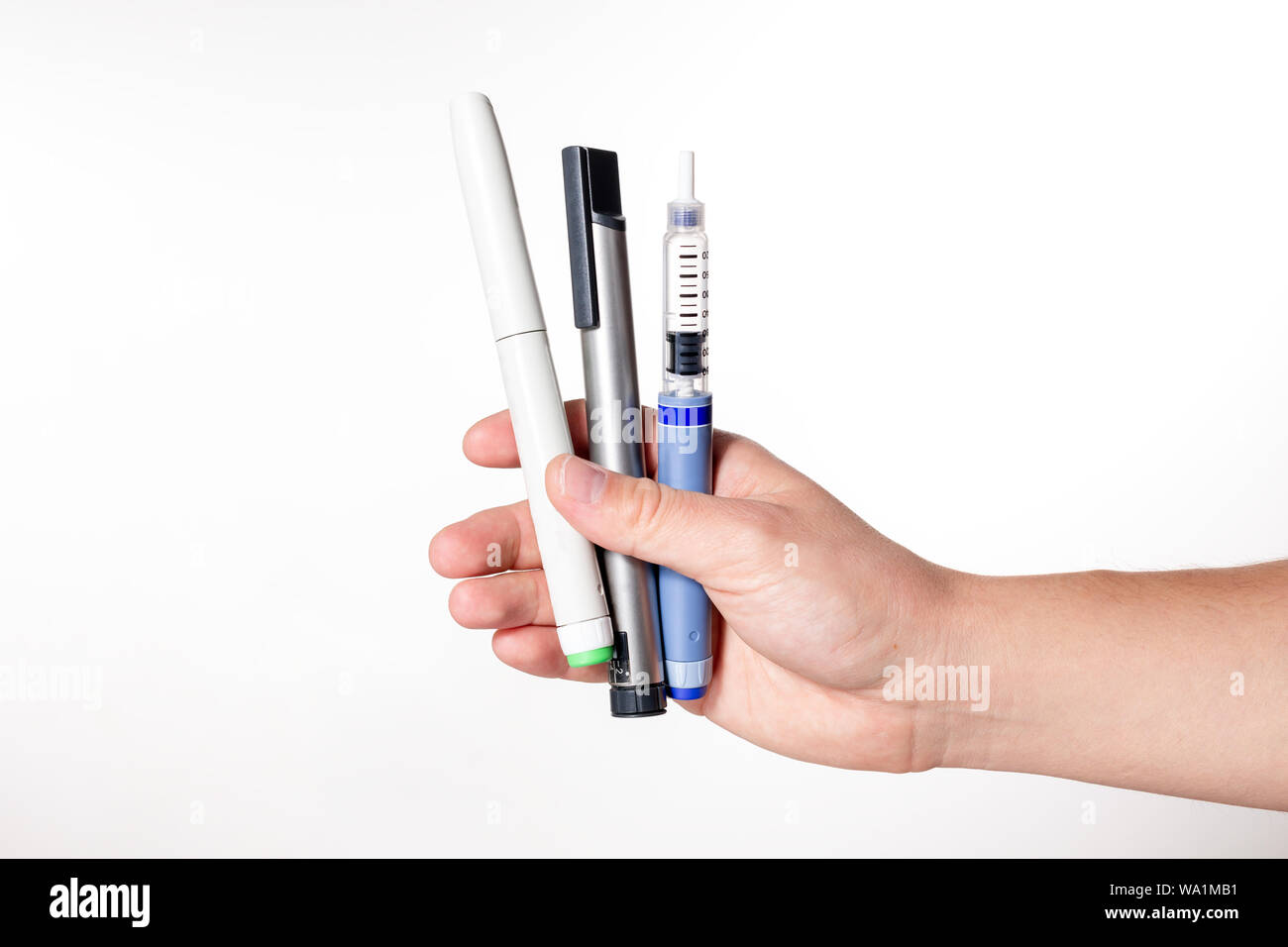 Hand holding insulin pen on isolated white background Stock Photo - Alamy