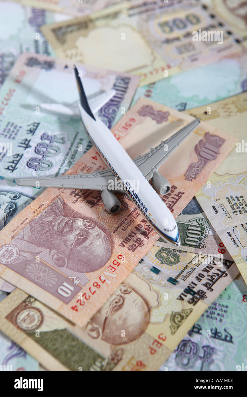 High angle view of model airplane with Indian currency Stock Photo - Alamy