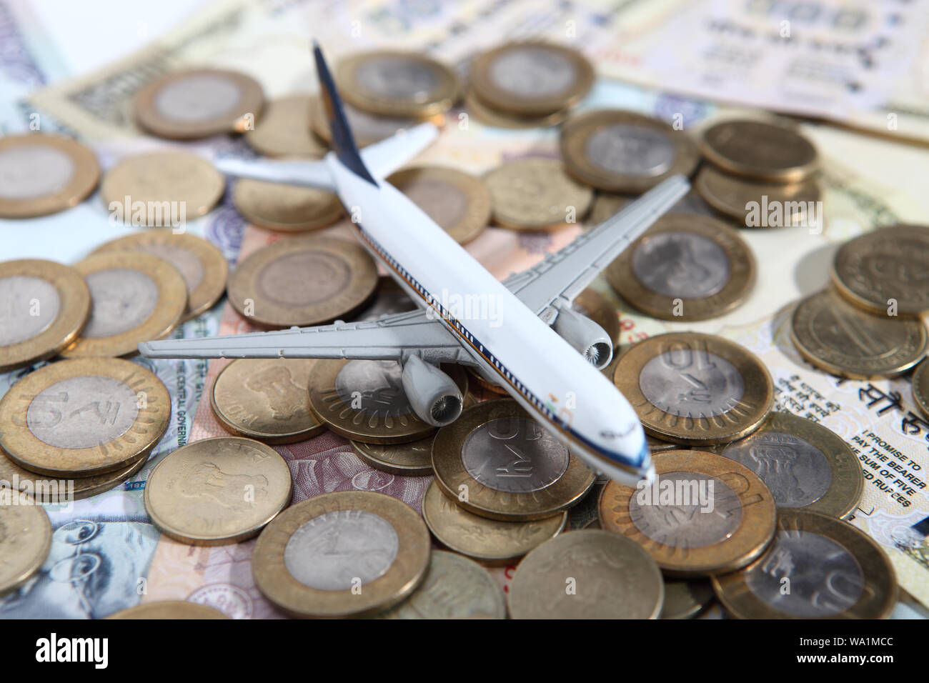 Model airplane with Indian currency Stock Photo - Alamy